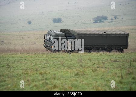 British army MAN SV HX 8x8 utility truck moving along a country track ...