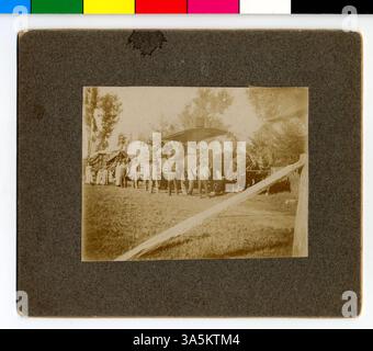 Photograph of a threshing crew working with a threshing machine and hay ...