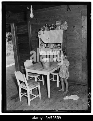 Daughter of Andrew Dutton, miner, living in company housing project ...