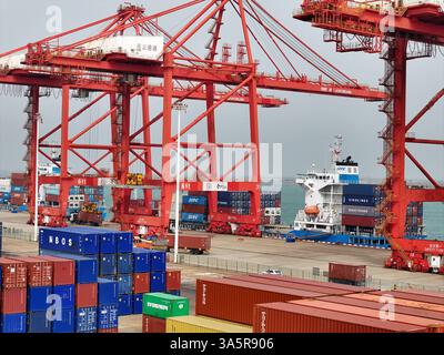 LIANYUNGANG, CHINA - MARCH 24, 2025 - Ocean cargo ships load and unload ...
