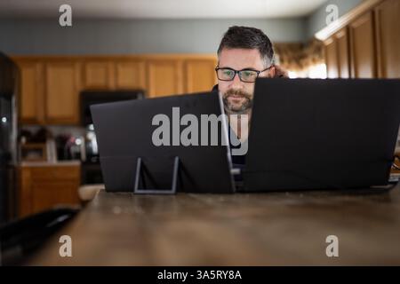 Middle age man with beard voting putting envelop in ballot box smiling ...