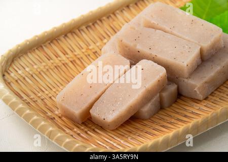 Raw konjac in square shape in a plate on white table background, also ...