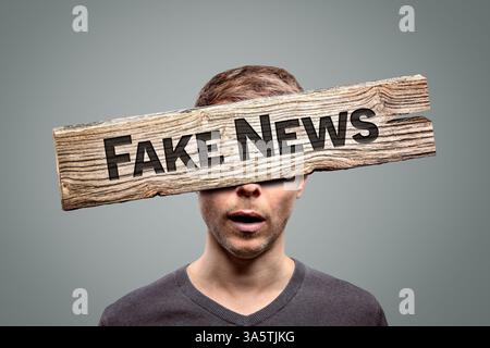 Fake sign in front of a person's head isolated from background Stock ...