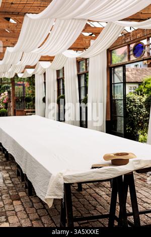 Cozy summer veranda featuring wooden accents, a long table with a white ...