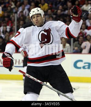 The New Jersey Devils' Mike Rupp knocks down a high puck against the ...
