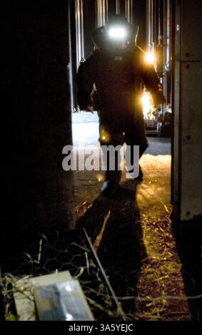 Army Staff Sgt. Sean Sandwick, left, gets assistance with donning a ...