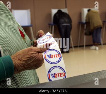 Alternate election judge Chavela Lozada watches voters and waits to ...