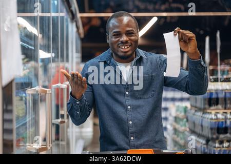 Disappointed with cost, holding check. Man customer is in the ...