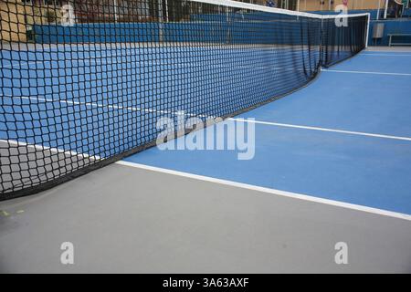 Outdoor fast tennis court made of cement and blue color with white ...
