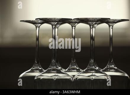 Upturned empty clean glasses on blurred background, closeup. Bokeh ...