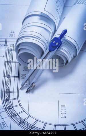 Rolls of blueprints and drawing compass construction concept Stock ...