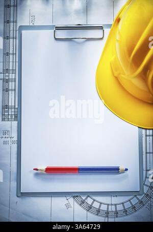 Clipboard pencil building helmet on blueprint construction concept ...