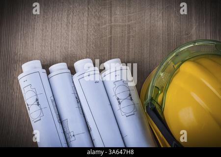 Plastic goggles blueprint rolls and building hat construction concept ...