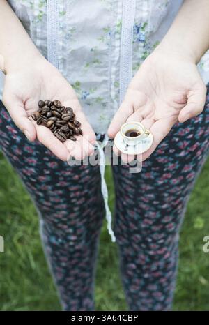 Hand hold very small cup of coffee Stock Photo - Alamy