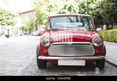 Vintage small red car on the street Stock Photo - Alamy