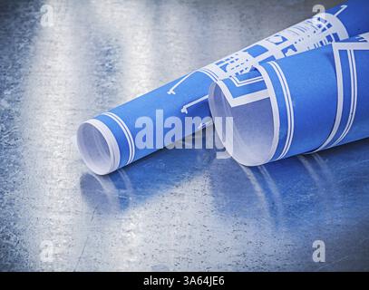 Blue engineering drawings on scratched metallic background construction ...