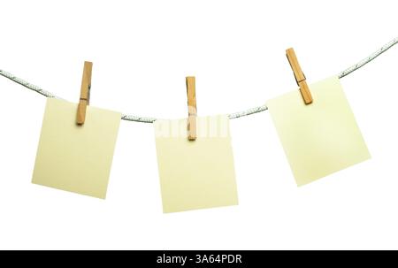 Note papers hooked on a rope. White isolated studio shot Stock Photo ...