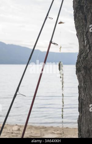 Fishing rods and mountain dam Stock Photo - Alamy