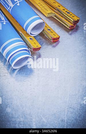 Composition of blue construction drawings wooden meter on metallic ...