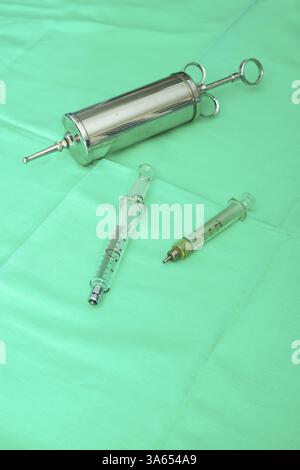 Big single-use syringe on metallic background top view medicine concept ...