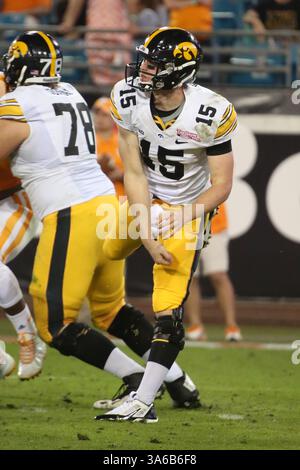 Iowa quarterback Jake Rudock (15) fumbles the ball as he is hit by Iowa ...