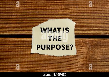 What is the purpose message written on ripped torn orange paper on pink ...