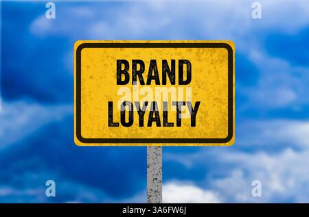 Brand loyalty message written on yellow metal sign on nature background ...