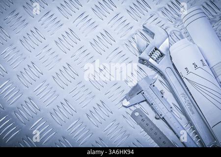 Engineering drawings vernier caliper monkey spanner on channeled metal ...