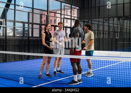 Group of friends playing padel tennis, enjoying friendly match on ...