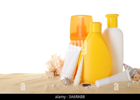 Different sun protection products, coral and seashells on sand against ...