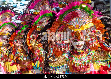 Colorful and elaborately costumed Masskara Festival dancers wearing ...
