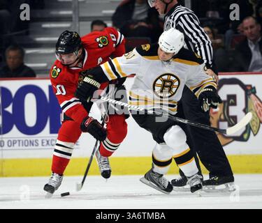 Boston Bruins' Phil Kessel, center, tries to control the puck against ...