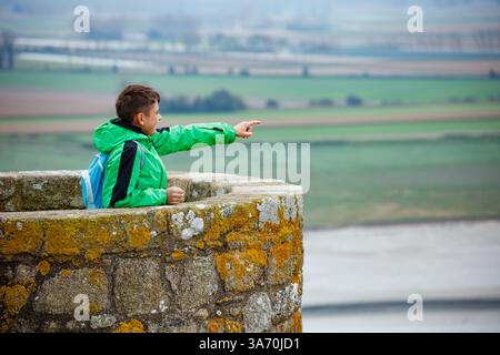 Top view of teen boy pointing upward as interface gesture isolated on ...