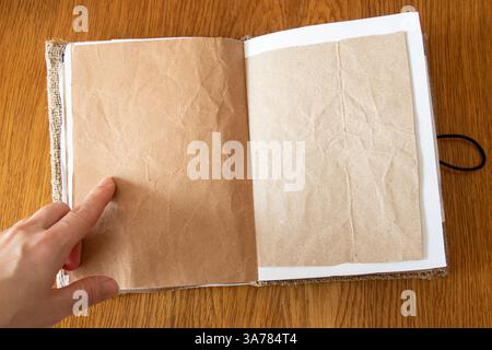 Blank notebook with kraft paper on a pink background with hearts. Form ...