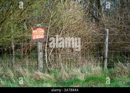 Old Rusty Warning Signe Do Not Start Fire behing the fence by the Woods ...