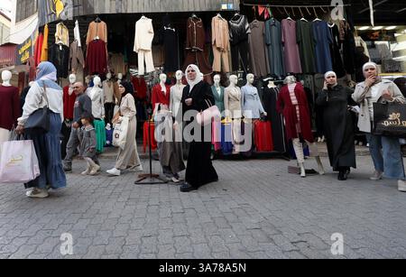 Nablus. 26th Mar, 2025. People shop at a market ahead of the Eid al ...