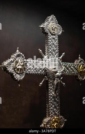 Silver crucifix in medieval Gothic style exposed with a background in ...