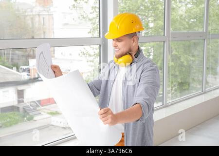 Male contractor with house plan near window in room, back view Stock ...