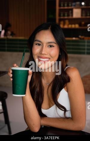 Young cute smiling asian woman writing notes in cozy spacious living ...