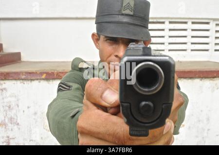 Uniformed police officer aiming pistol tactical firearms training ...