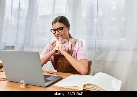 Woman in graduation cap at desk on blue background Stock Photo - Alamy