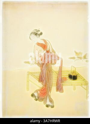 A serene figure dressed in traditional attire stands by a calm body of ...