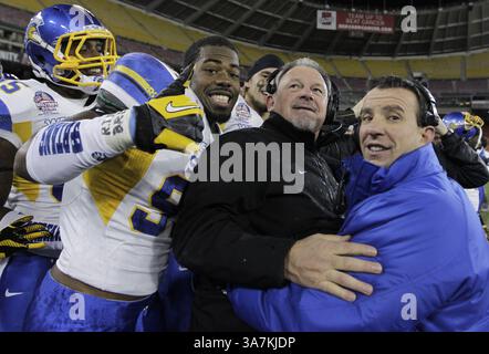 Kent State interim head coach Mark Carney jogs to the sideline after a ...