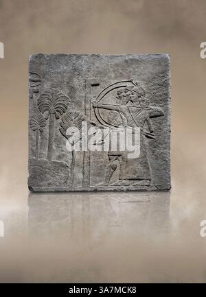 Ancient wall with bas-relief with assyrian warriors with spears ...