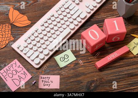 Computer keyboard, calendar and sticky notes on wooden background ...