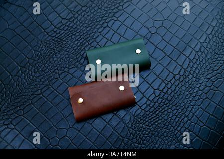 Two leather key holders, placed on a black color crocodile sheet Stock ...