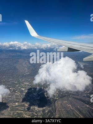 Airplane wing and winglet soaring above the clouds. Aerial view from a ...