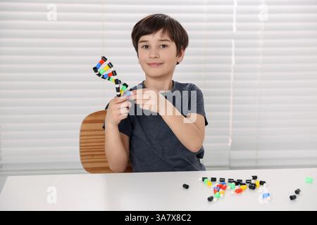 Boy with DNA structure model at desk indoors Stock Photo - Alamy
