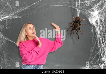 Scared woman and cobweb with spider against brown background ...
