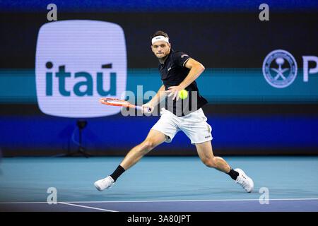 Taylor Fritz returns a shot to Matteo Berrettini, of Italy, at the BNP ...